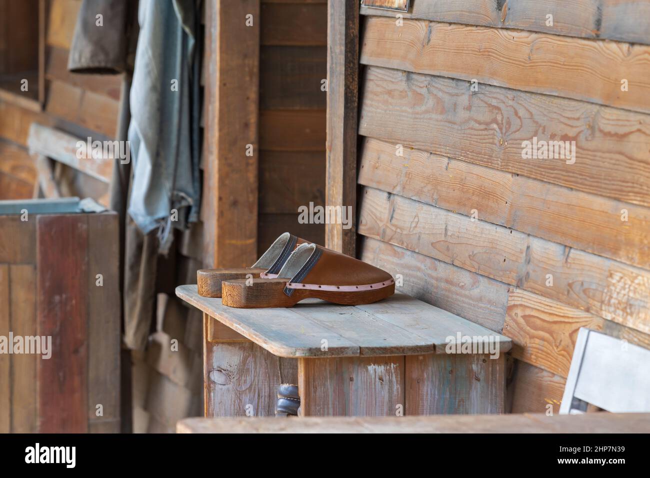 Old wooden shoebox near a wooden cottage on a farm. The shoe box has ...