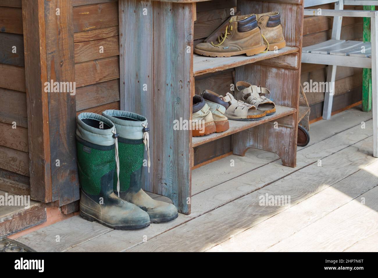 Old wooden shoebox near a wooden cottage on a farm. The shoe box has ...