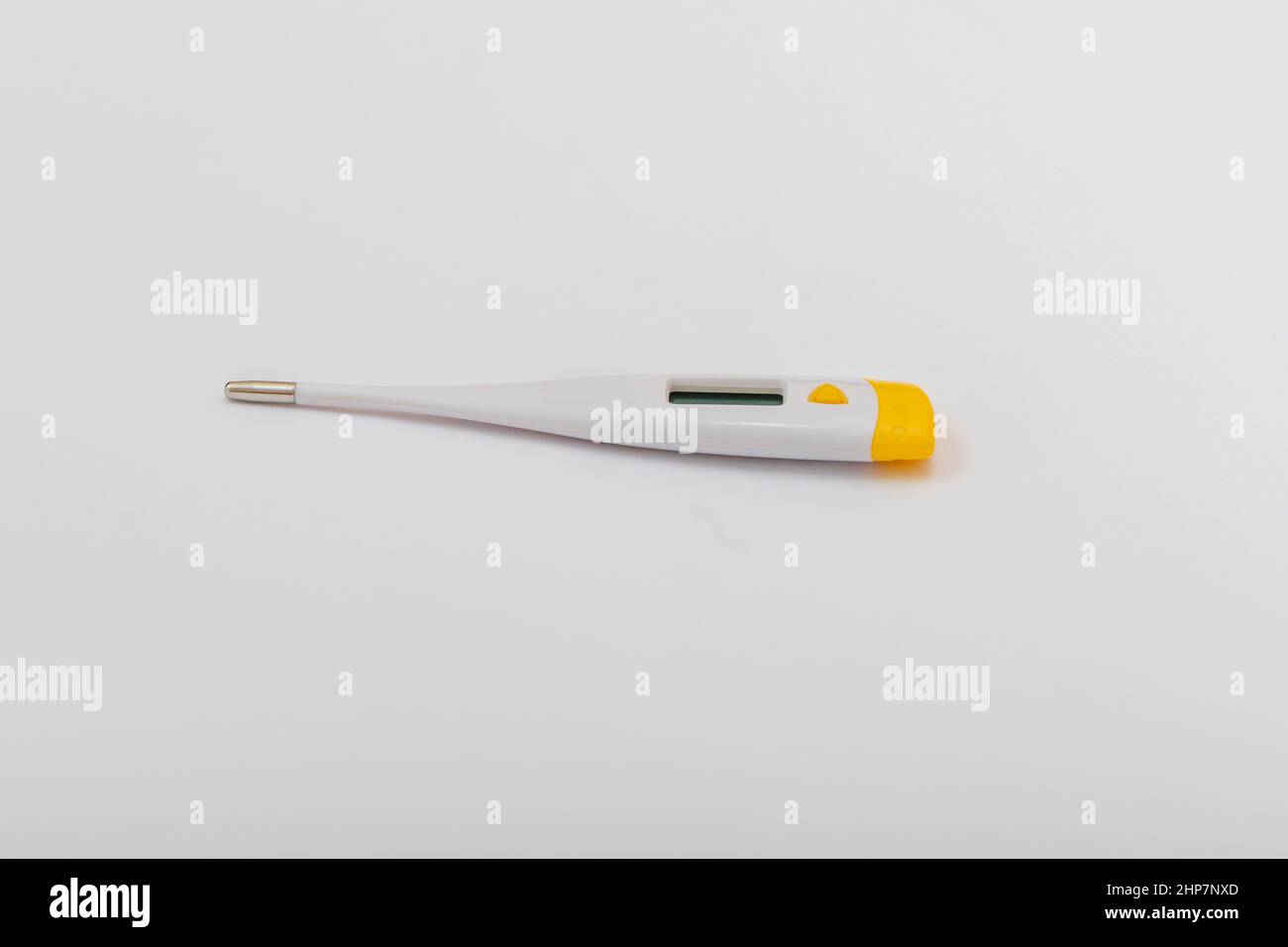 White-yellow digital thermometer for measuring body temperature. The ...