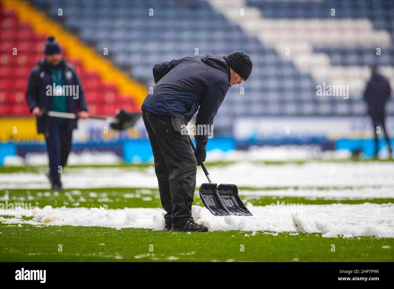Blackburn rovers staff clearing the snow of the pitch Stock Photo - Alamy