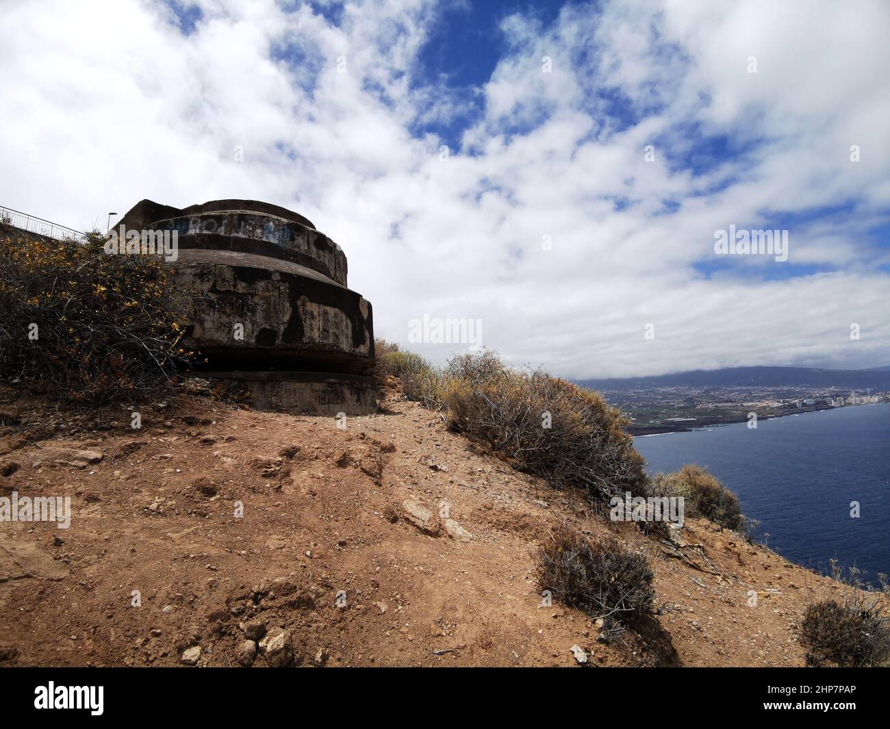 Old bunker against a blue cloudy sky Stock Photo - Alamy