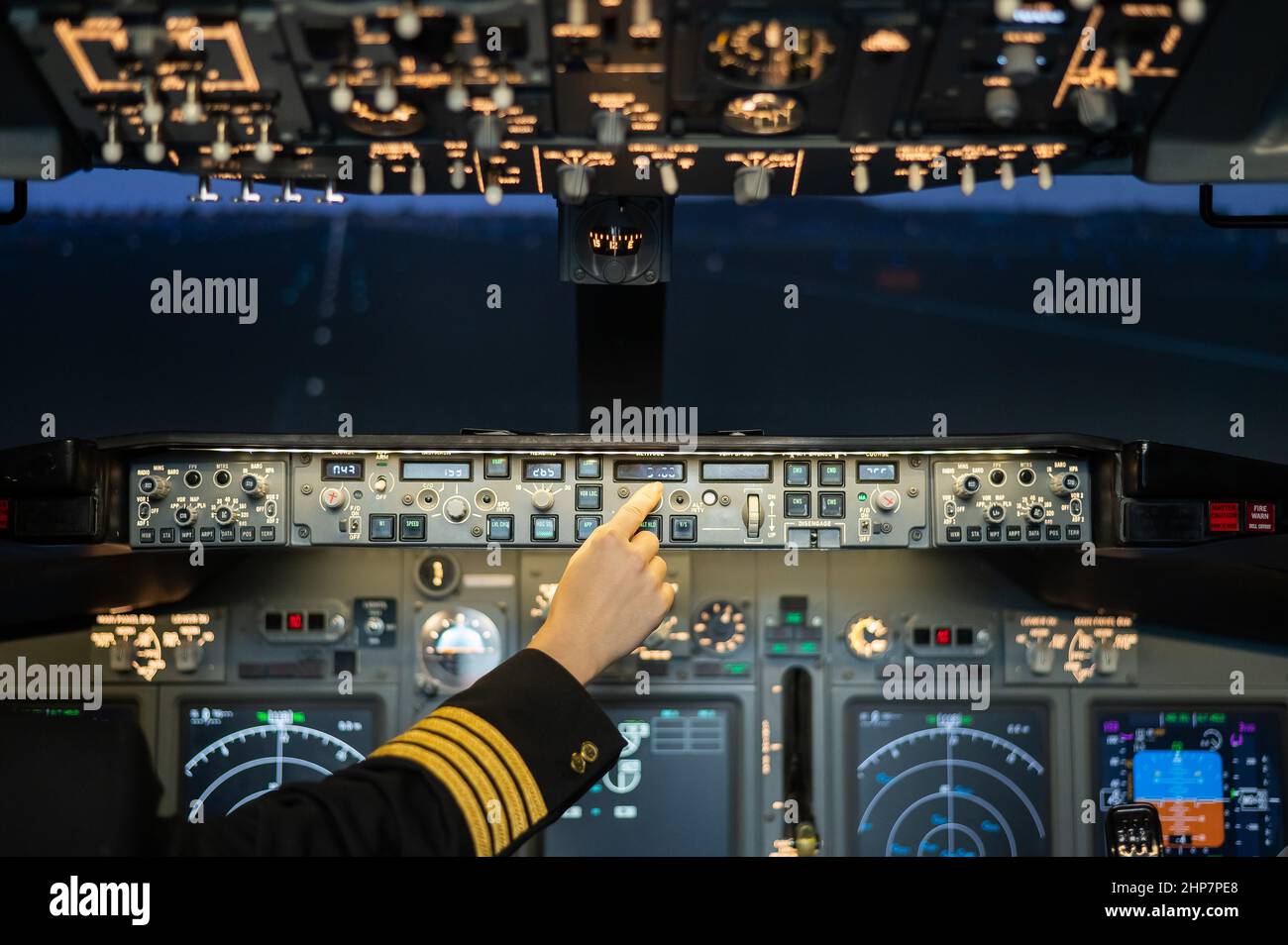 Close-up of a pilot's hand on an airplane control panel Stock Photo - Alamy