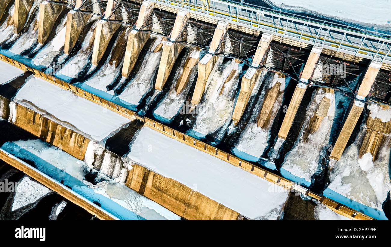 Water flows from the dam with a thin icy layer Stock Photo - Alamy