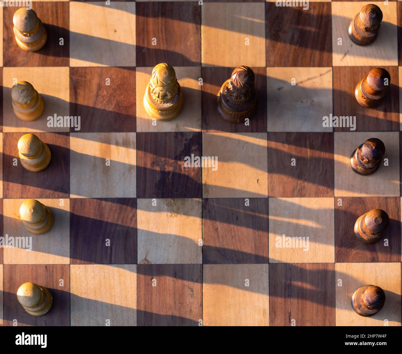 Wooden chess board with wooden pieces with sunlight. Selective focus ...
