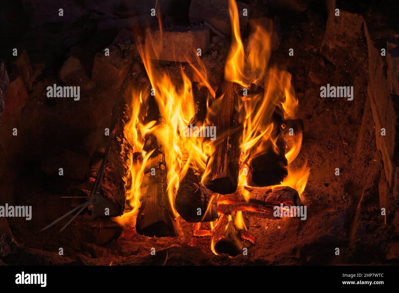 Logs on fire with flames in fireplace Stock Photo - Alamy