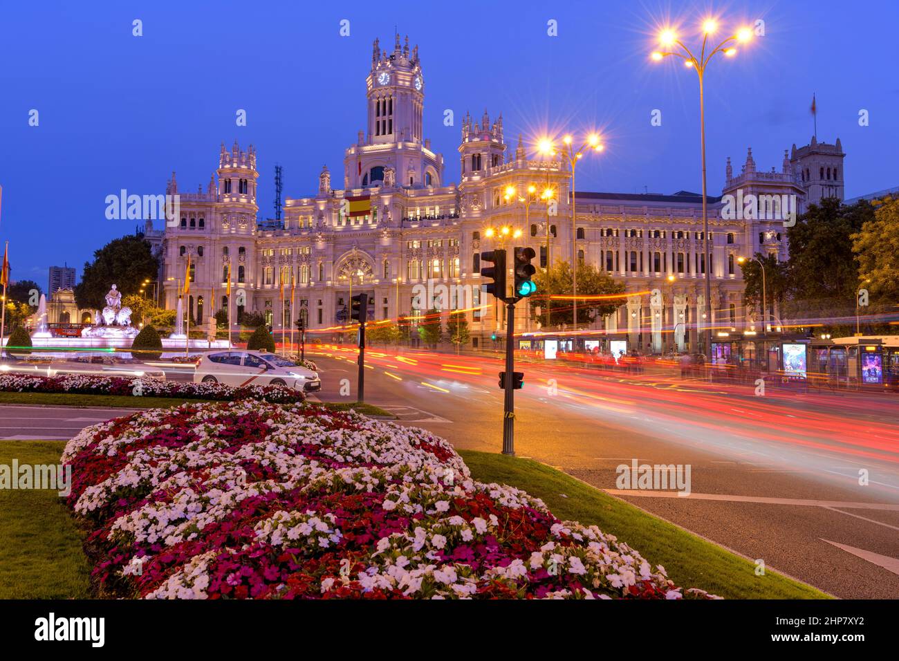 Madrid at Dusk - A dusk view of busy streets at Cybele Plaza in front ...