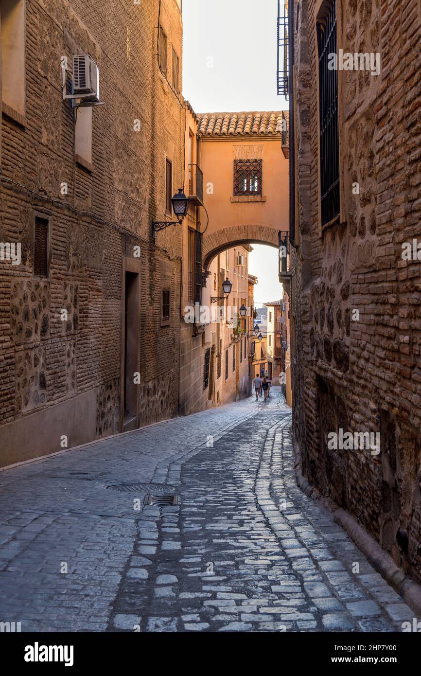 A narrow cobblestone street alley in the old town hi-res stock ...