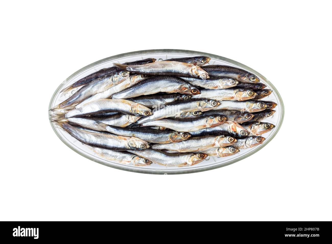salted fish european anchovy on an oval glass plate isolated on a white ...