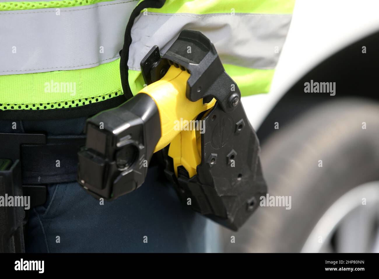 Detail of Lithuanian police officers with glock pistol and electric ...