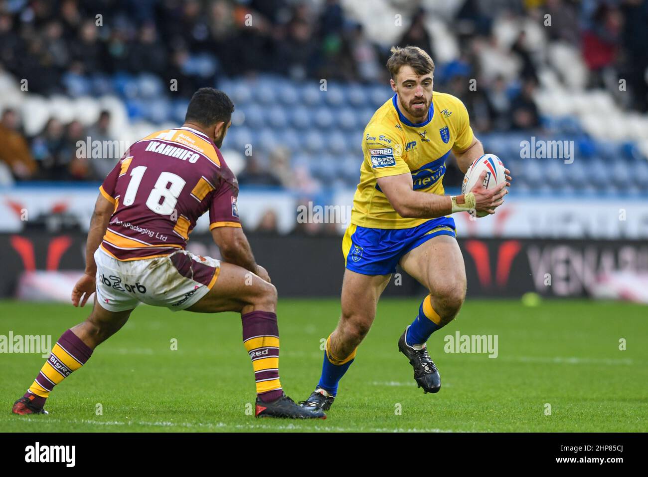 Tom Garratt #26 of Hull KR looks to run past Sebastine Ikahihifo #18 of ...