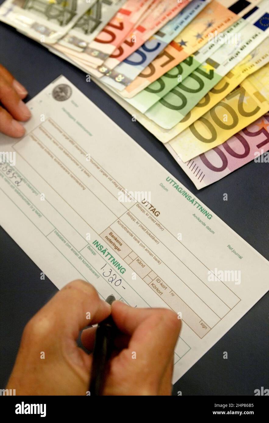 Different euro banknotes in a bank. The euro (symbol: €; code: EUR) is ...