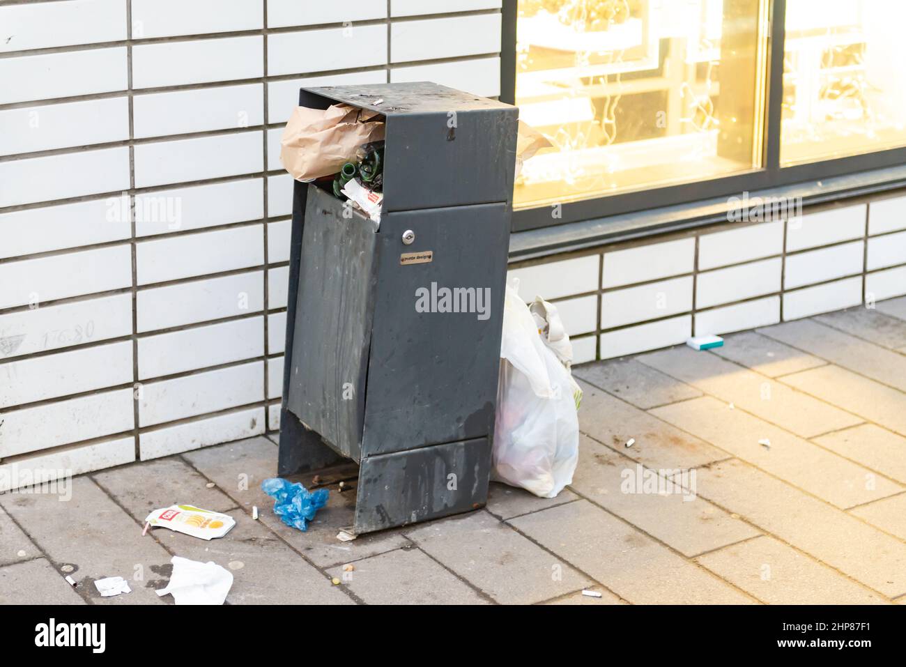Garbage bins in the yard. An overflowing urn near the entrance of an ...