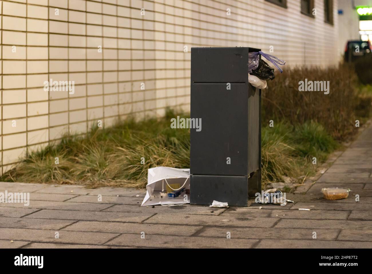 Garbage bins in the yard. An overflowing urn near the entrance of an ...
