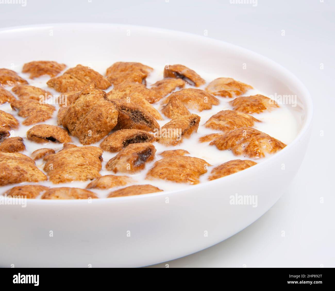 Crispy pads chocolate pillows with milk in dish isolated on the white ...