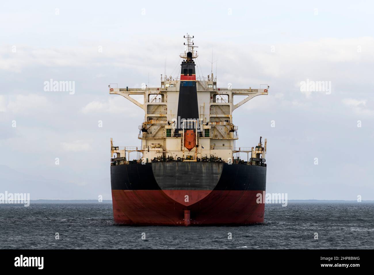 Cargo ship at anchor on the road. Bulk cargo vessel at sea. Logistics ...