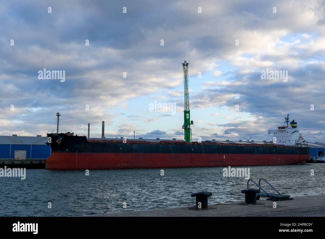 Bulk cargo vessel moored in port. Loading of cargo Stock Photo - Alamy