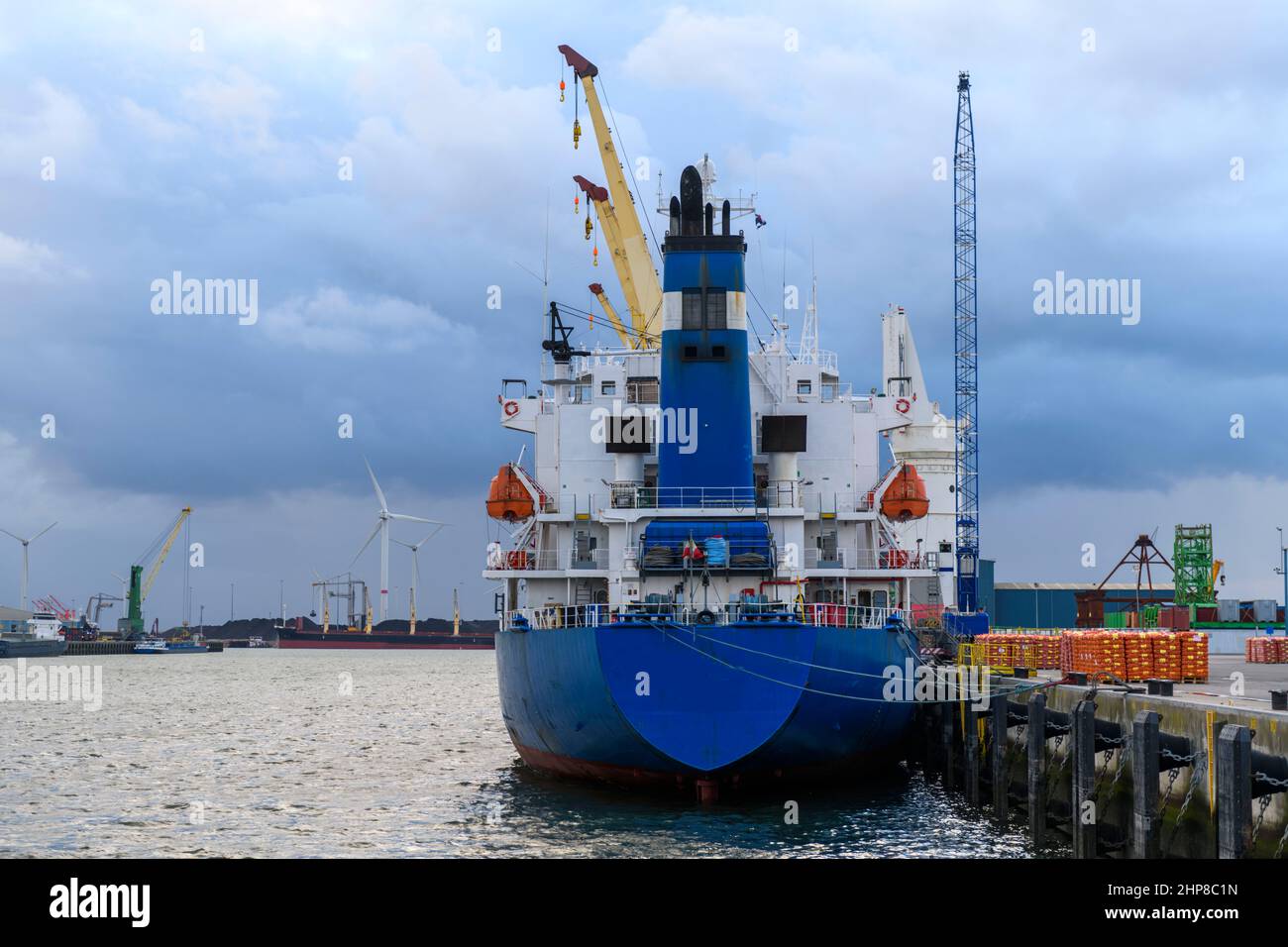 Blue refrigerated cargo vessel moored in port. Loading of cargo Stock ...