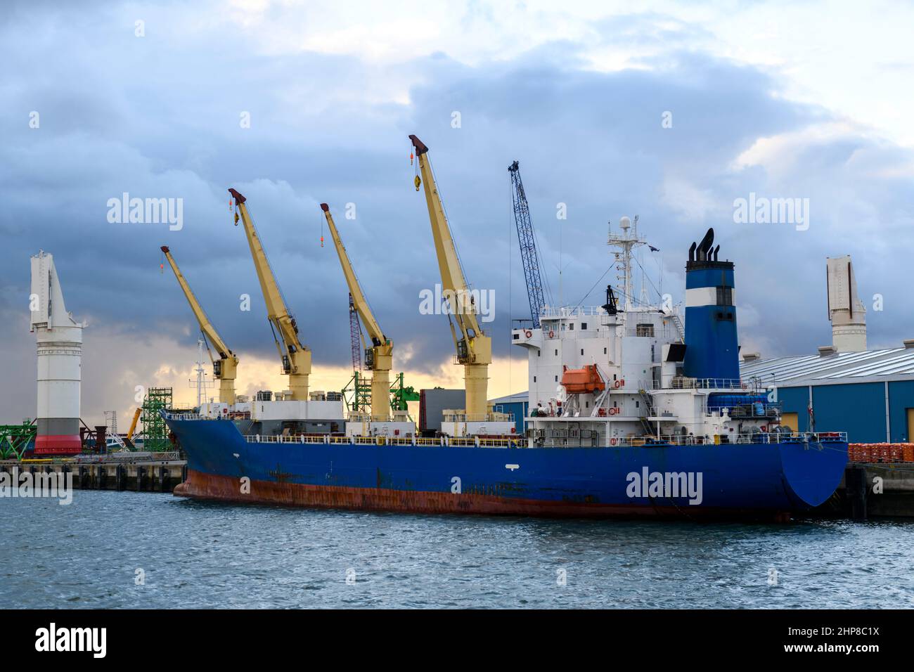 Blue refrigerated cargo vessel moored in port. Loading of cargo Stock ...