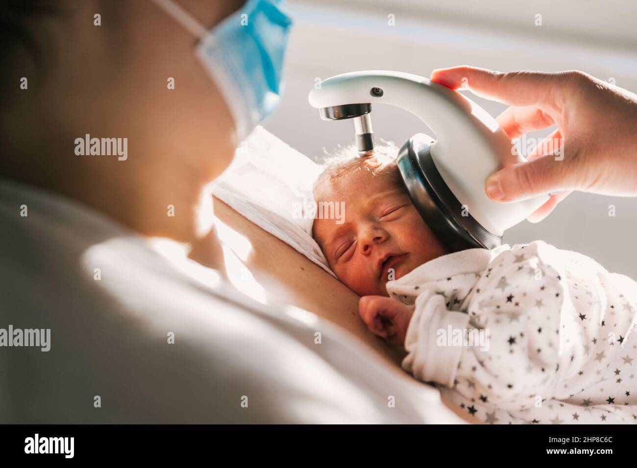 Mother doing ABR screening to baby in hospital Stock Photo - Alamy