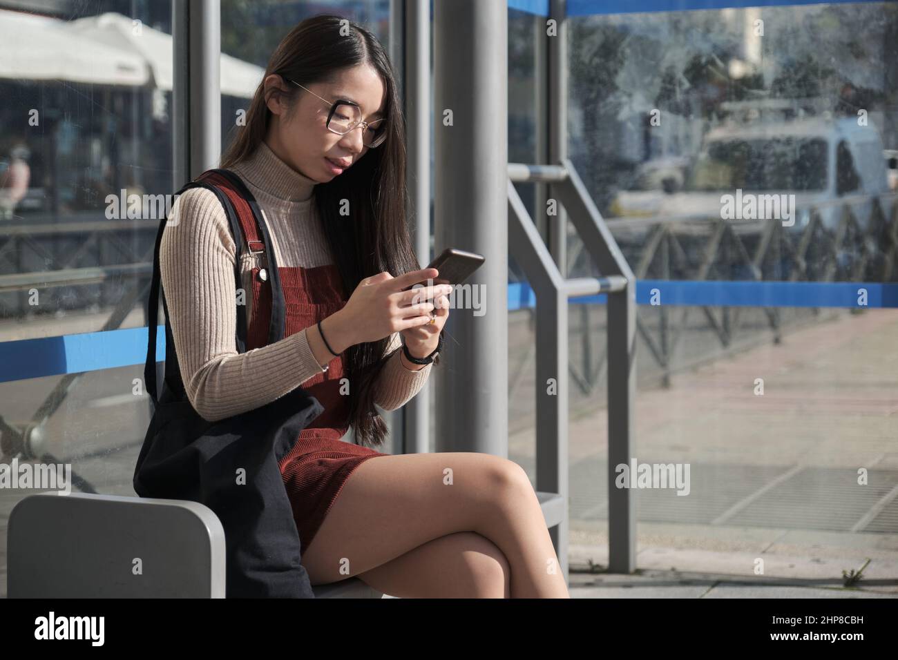 Chinese woman waiting bus stop hi-res stock photography and images - Alamy