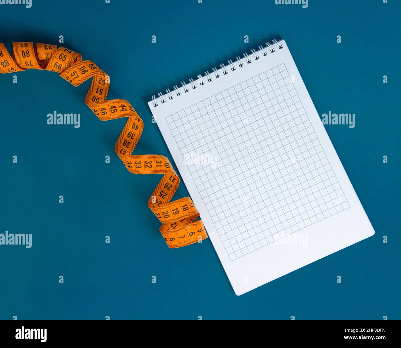 Colorful spiral tape measure and notebook on bright background Stock ...