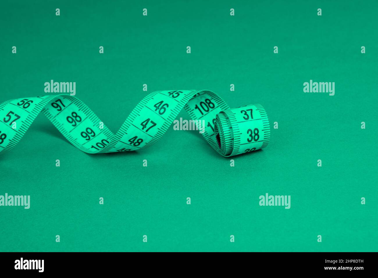 Colorful spiral tape measure on color background with space for text ...