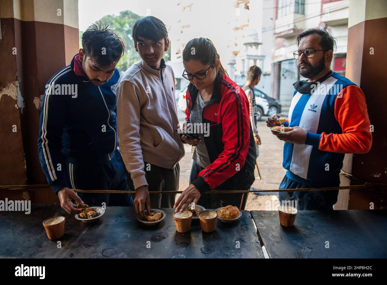 Lucknow, India. 18th Feb, 2022. Students having kulhad tea and snacks ...