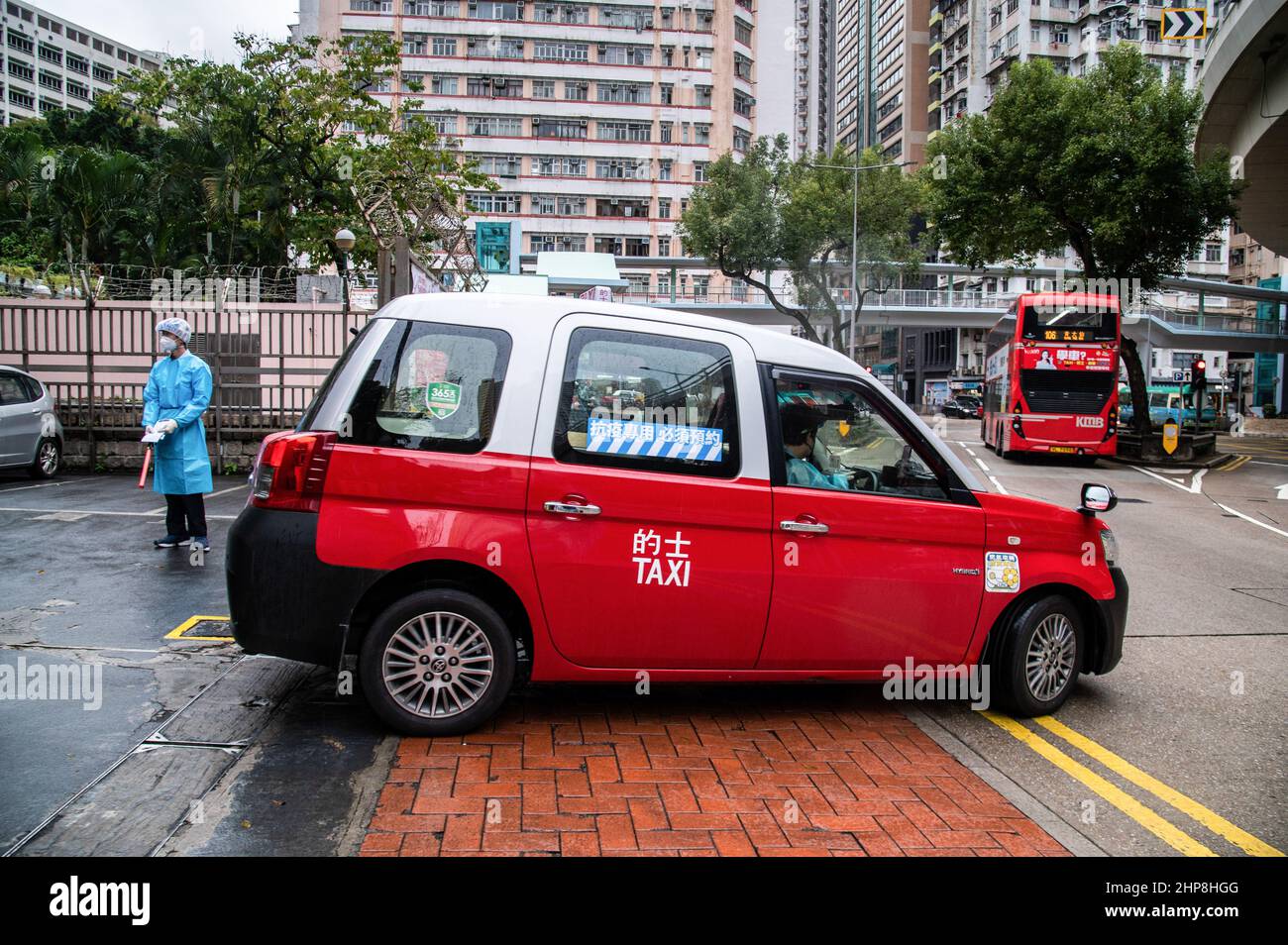 A taxi departs a COVID-19 clinic in Shau Kei Wan after dropping off its ...