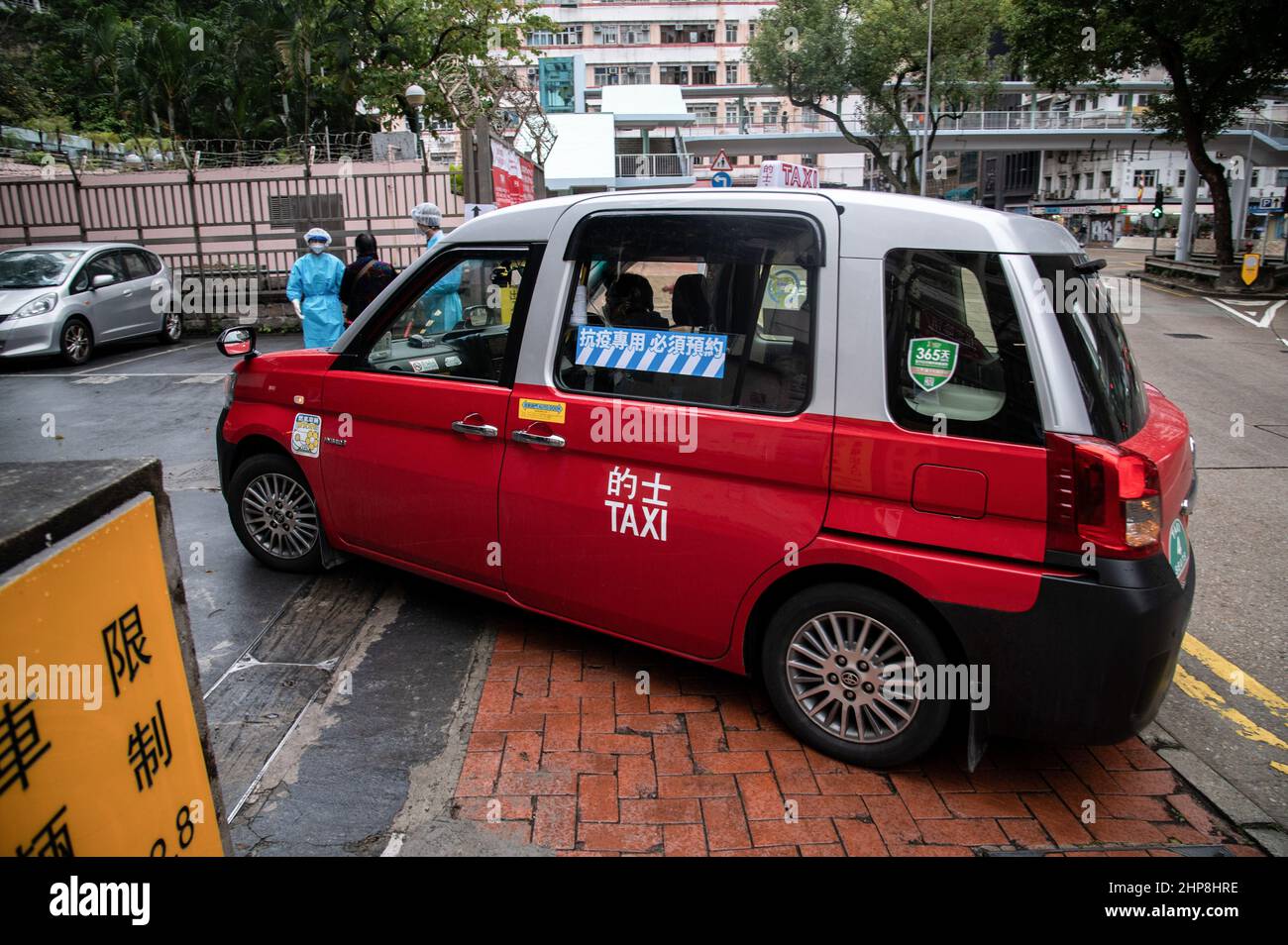 A designated COVID-19 taxi pulls into a COVID-19 clinic in Shau Kei Wan ...