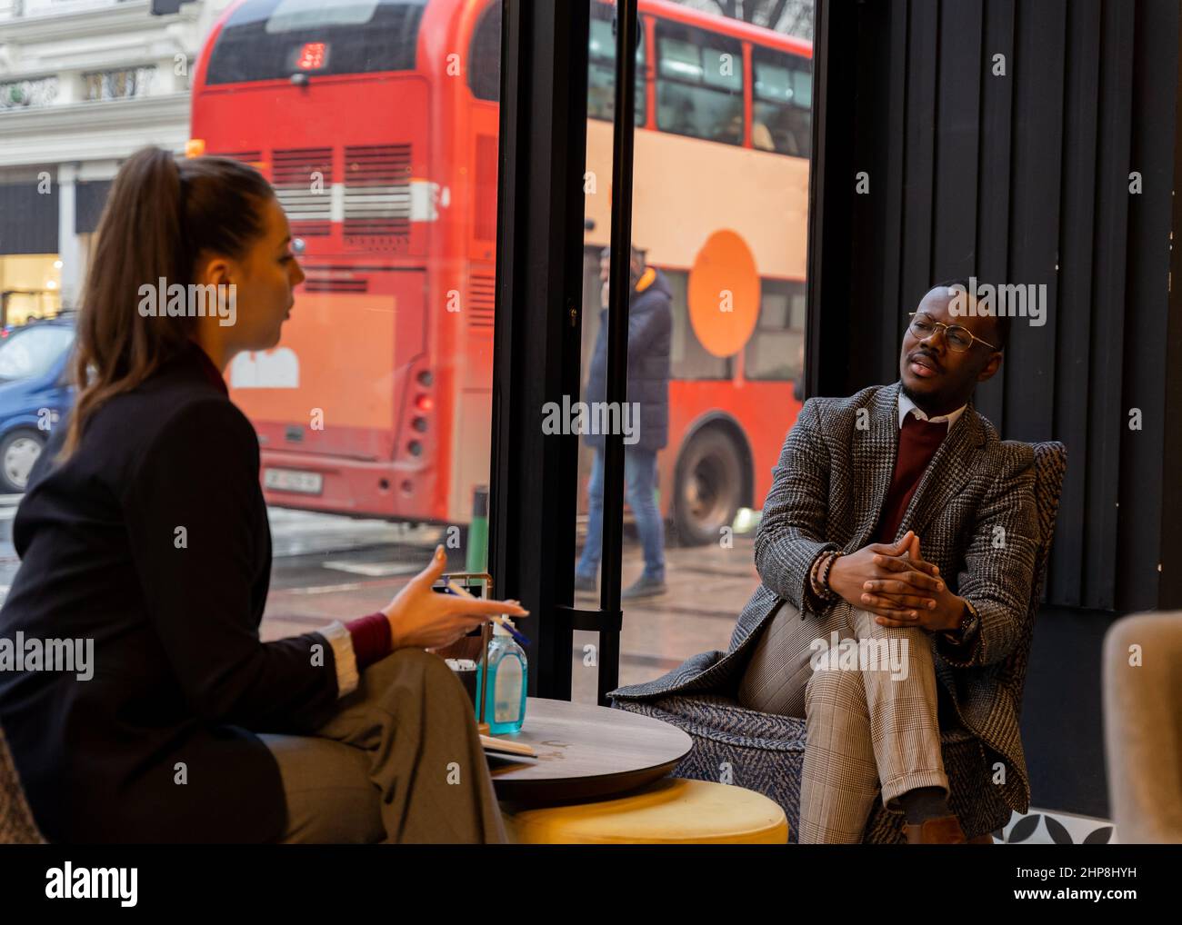 Two multiracial business people are having an interview while sitting ...