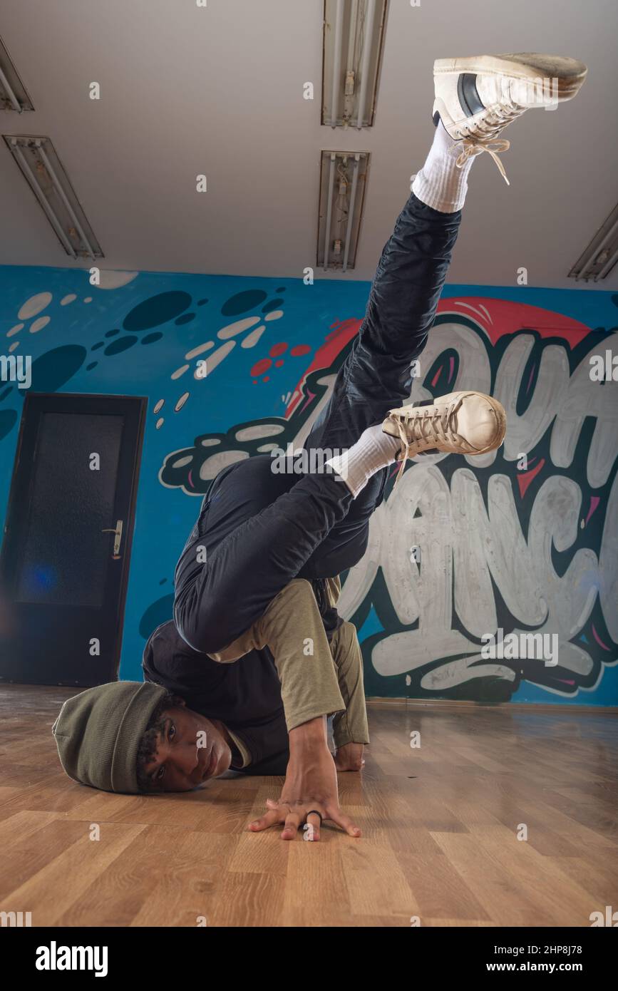Modern rapper dancing in garage. Urban lifestyle, hip hop Stock Photo ...