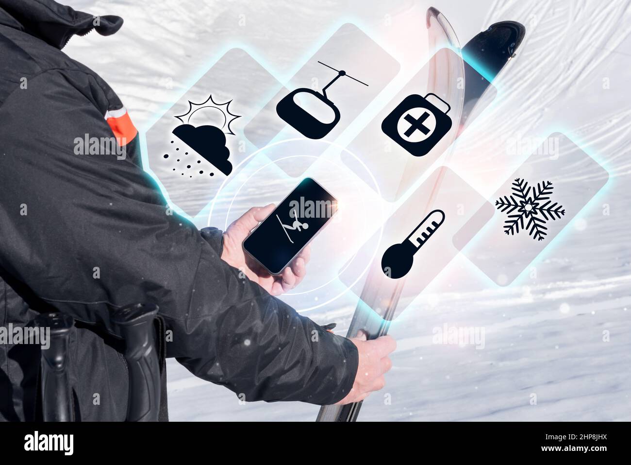 Skier checking the real-time status of the ski resort on his cell phone ...