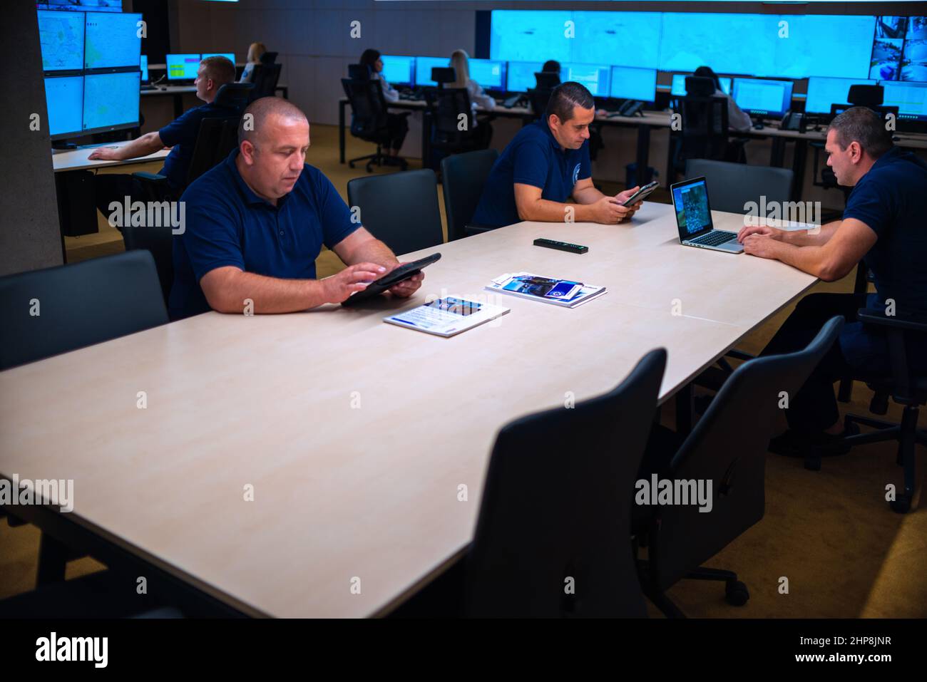 Group (security officers) tech guys meeting in a main security data ...