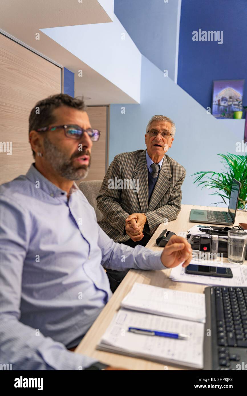 Two senior businessmen having discussion hi-res stock photography and ...