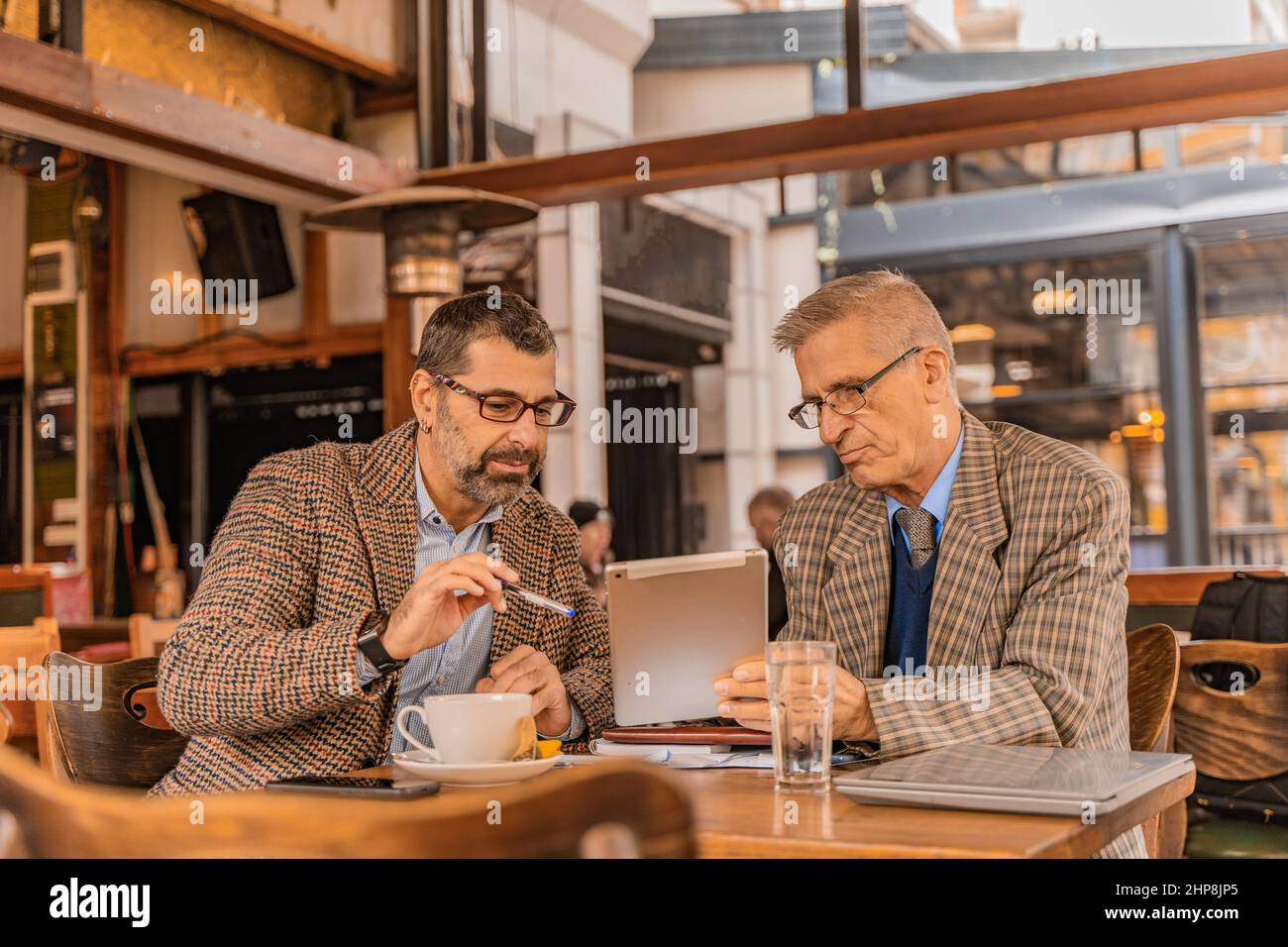 Two senior businessmen are thinking a lot about the plans Stock Photo ...