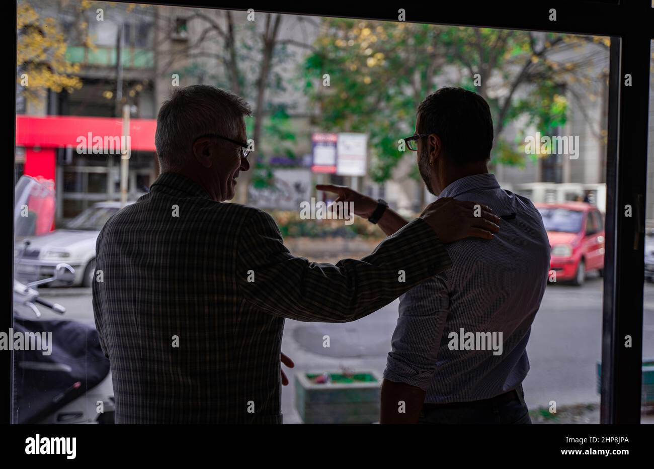 Two senior businessmen are acknowledging each other while talking ...