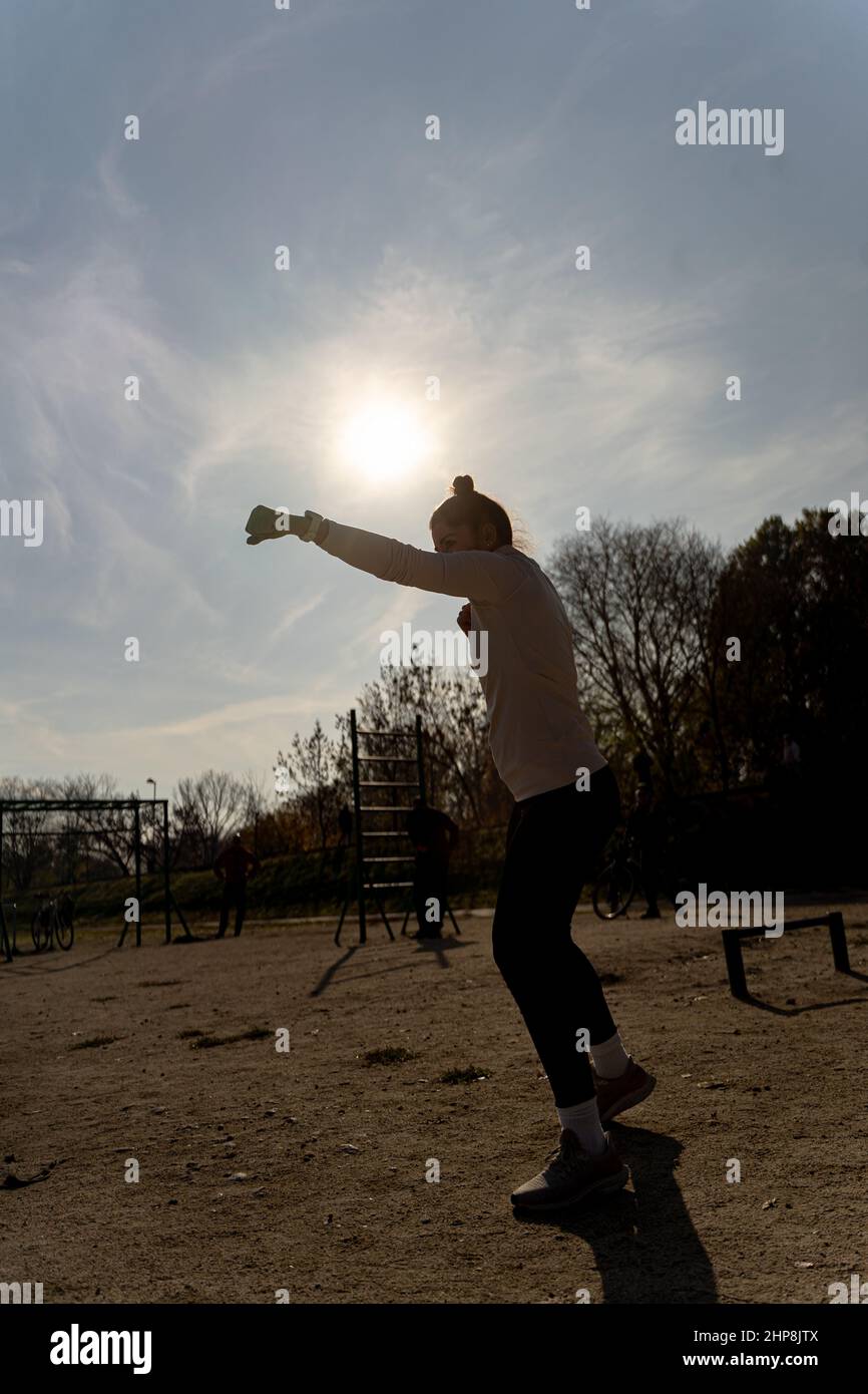 Amazing and attractive fit girl is exercising kickbox, silhouette Stock ...
