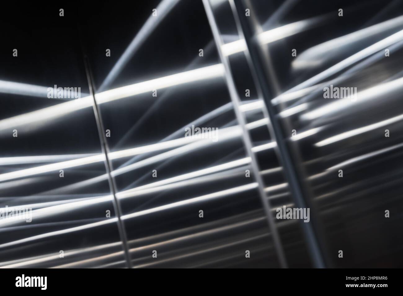 Brushed shiny metal wall with blurred reflections pattern, abstract ...