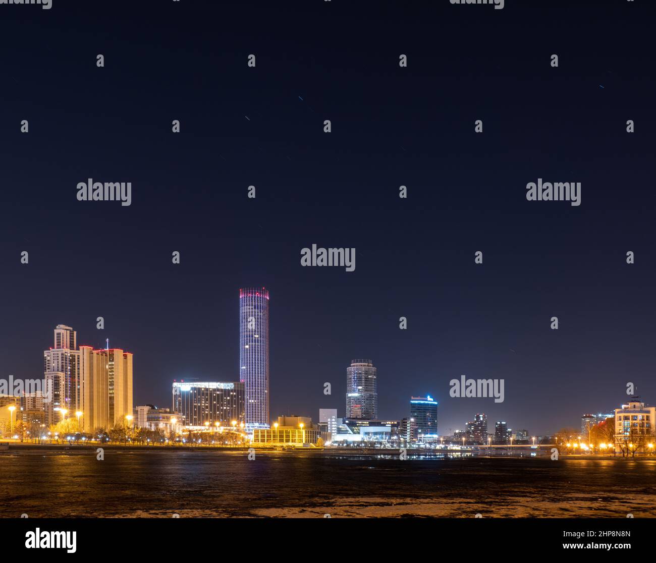 Early Spring night on the banks of the pond in the city center ...