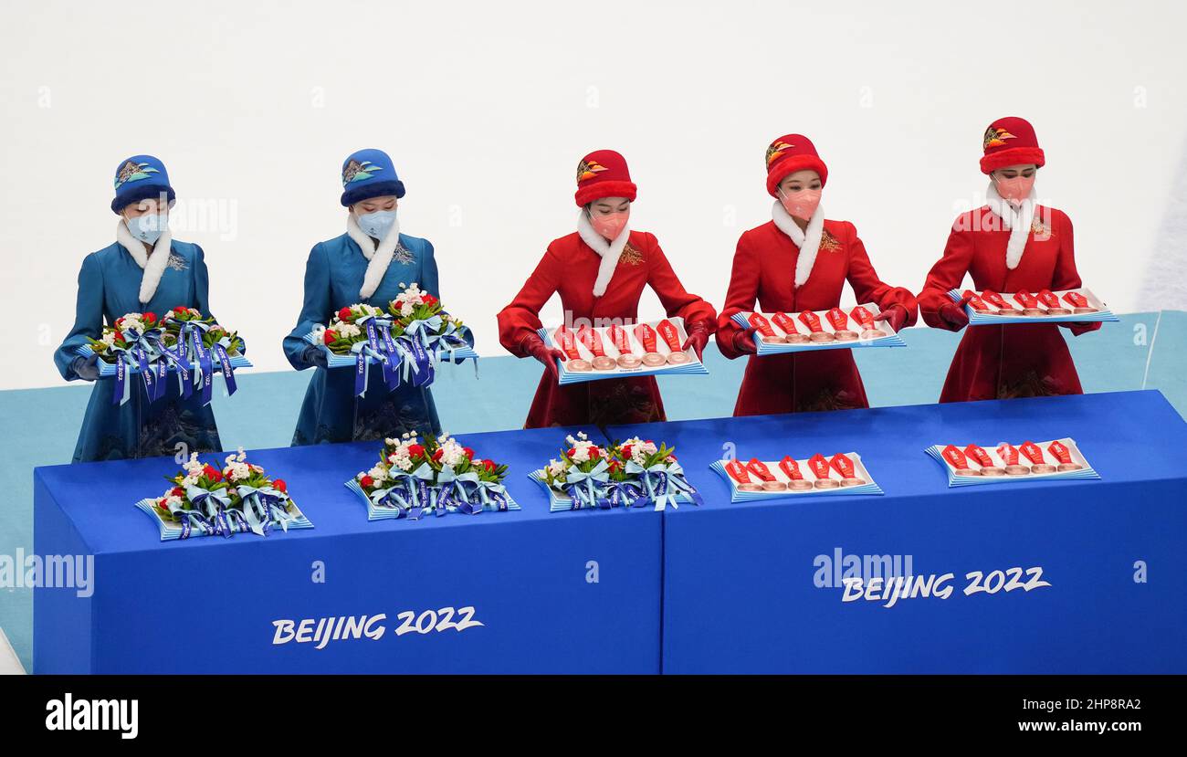 Beijing, China. 19th Feb, 2022. Volunteers prepare medals and flowers ...