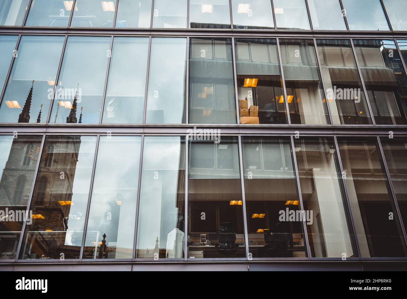 Glass wall of a skyscraper. Reflection of the building in the windows ...