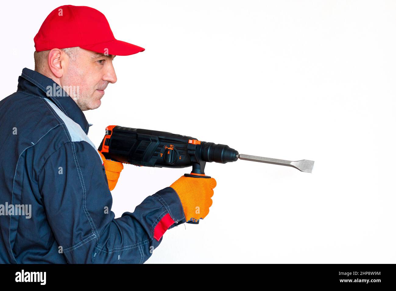 workman with a rotary hammer. worker, professional with hammer drill ...