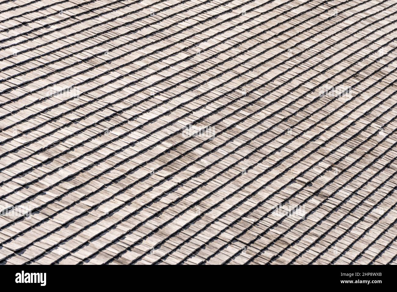 Weathered and faded from the sun, rain and snow wooden shingles that ...
