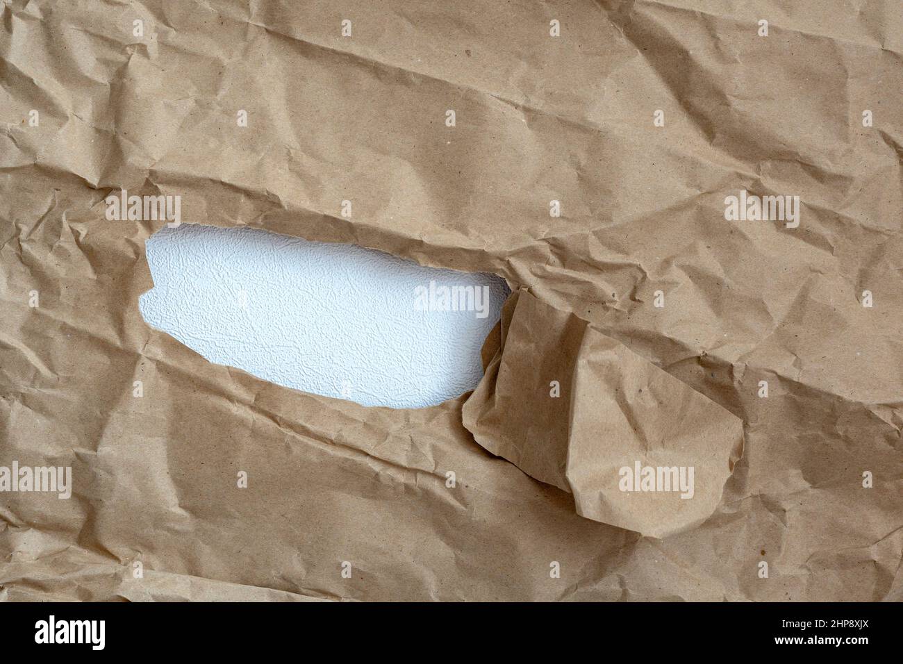 hole in paper with color paper background inside. Good paper texture ...