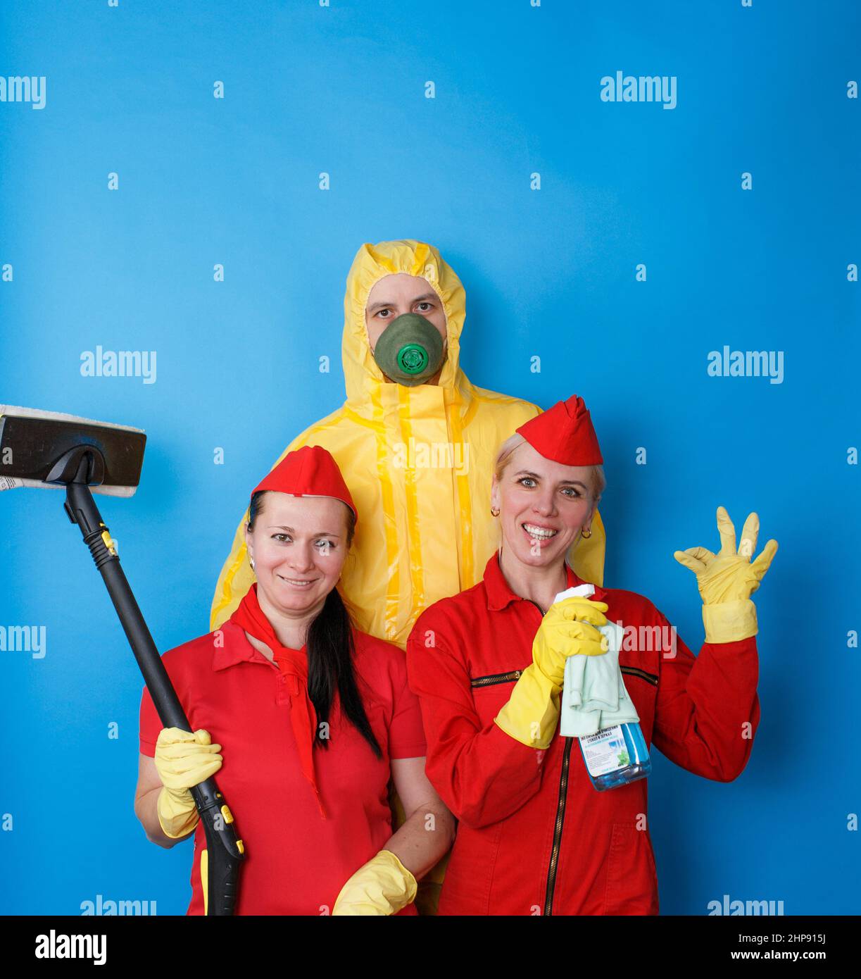 Cleaning company employees in work uniforms on an isolated blue ...
