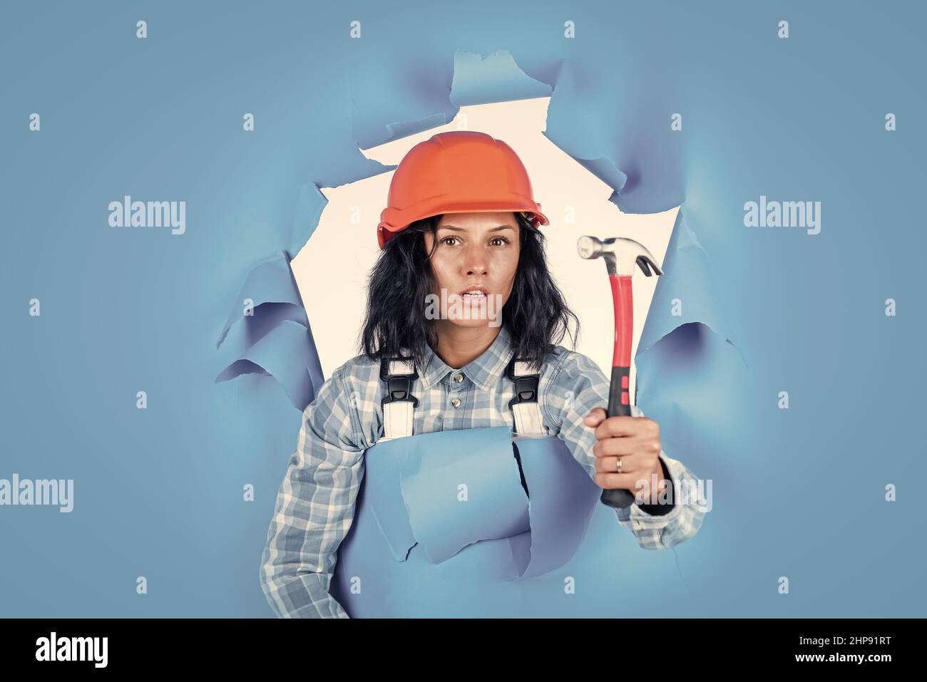 builder assistant repair and fix. female worker in working uniform ...