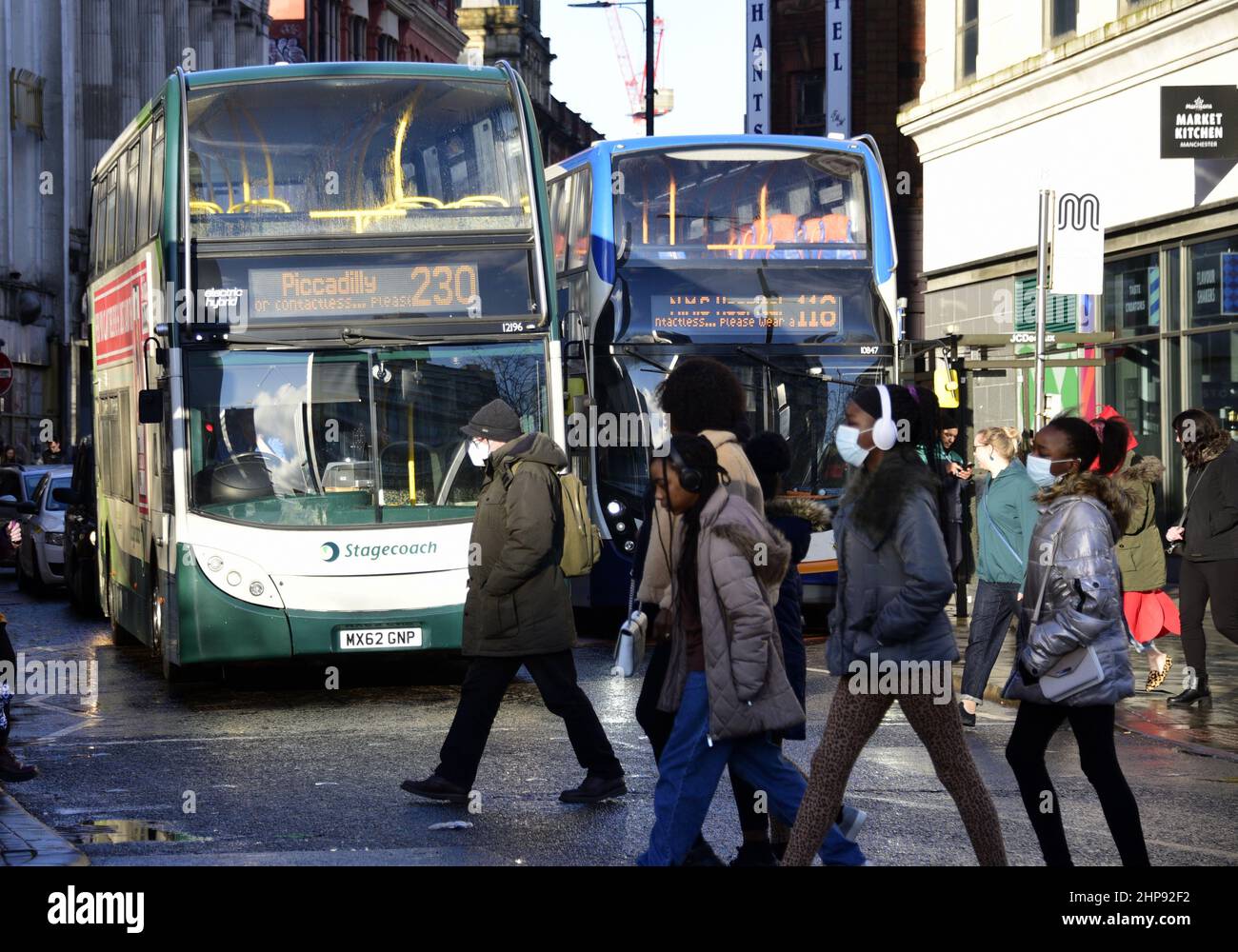People walk past Stagecoach buses in central Manchester Stock Photo - Alamy