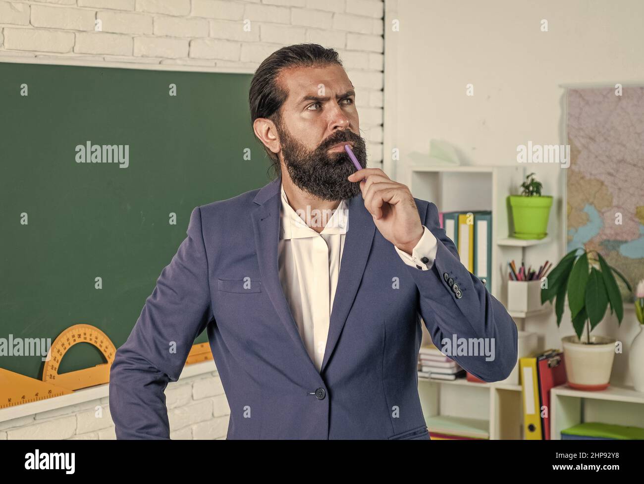 mature bearded man teacher in costume in school classroom with ...