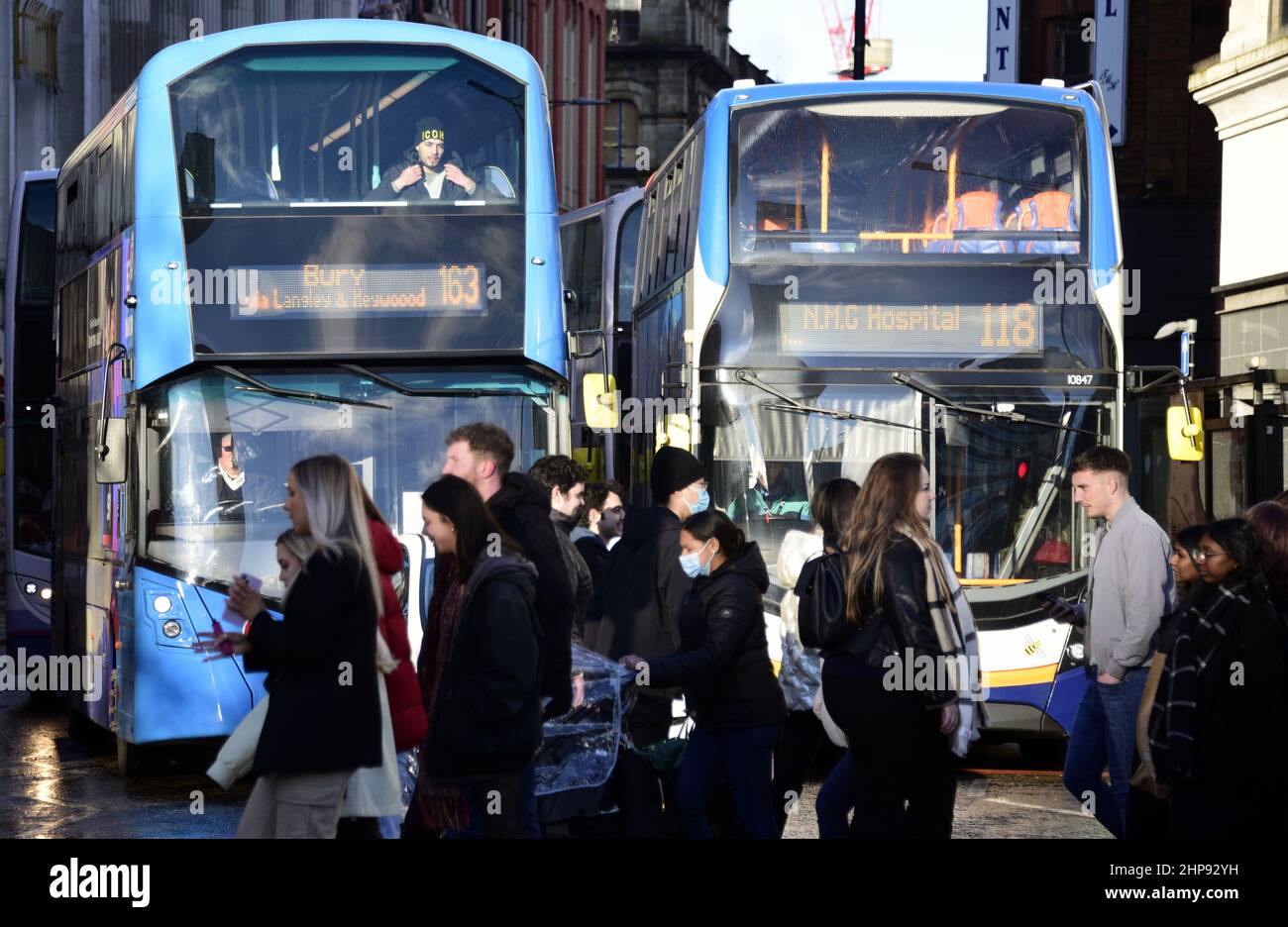 People walk past Stagecoach buses in central Manchester Stock Photo - Alamy