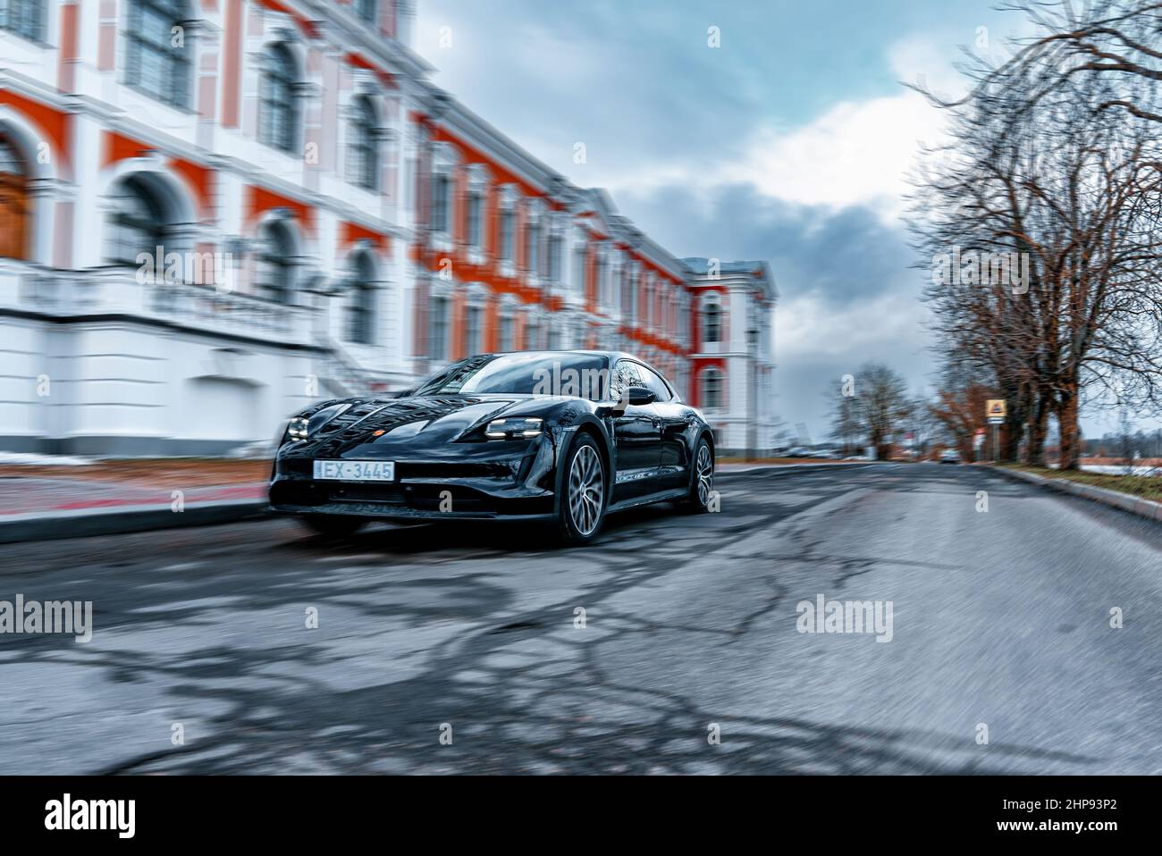 Porsche Taycan Gran Turismo Electric model driving down the road Stock ...